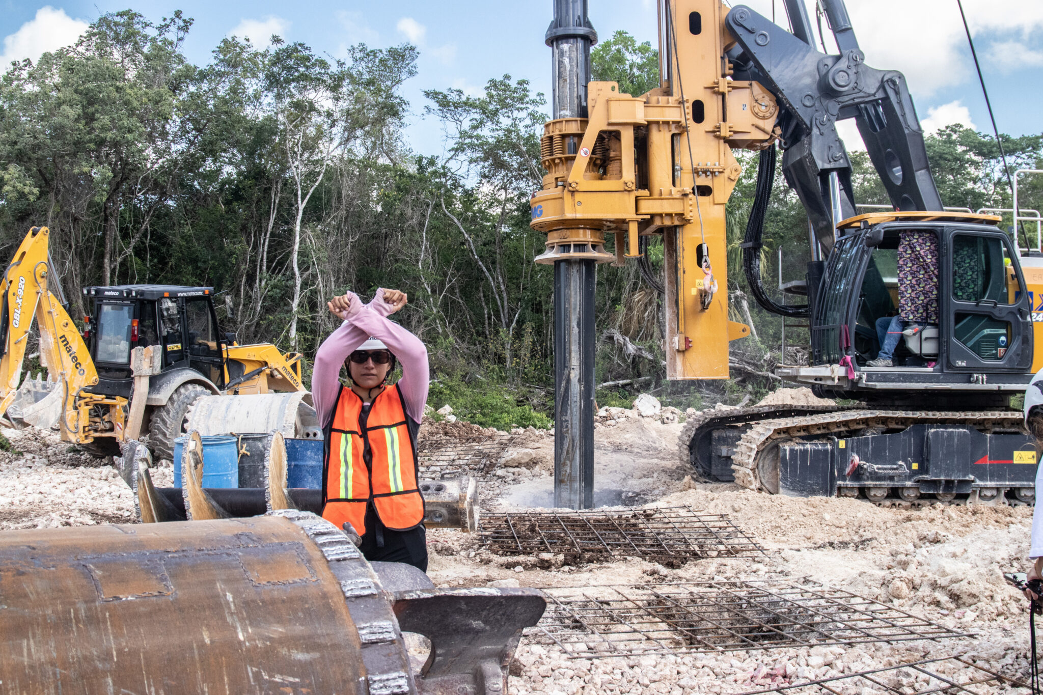 A protester stands in front of one of the piledrivers on tram five of ...
